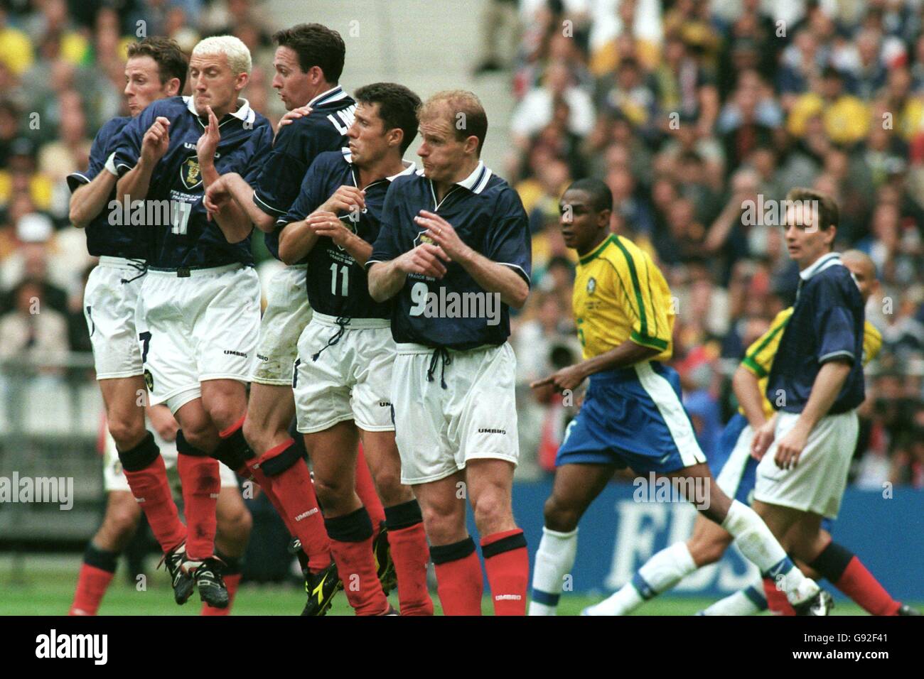 Scotland's wall (second from right) tries to block a Brazil free kick ...