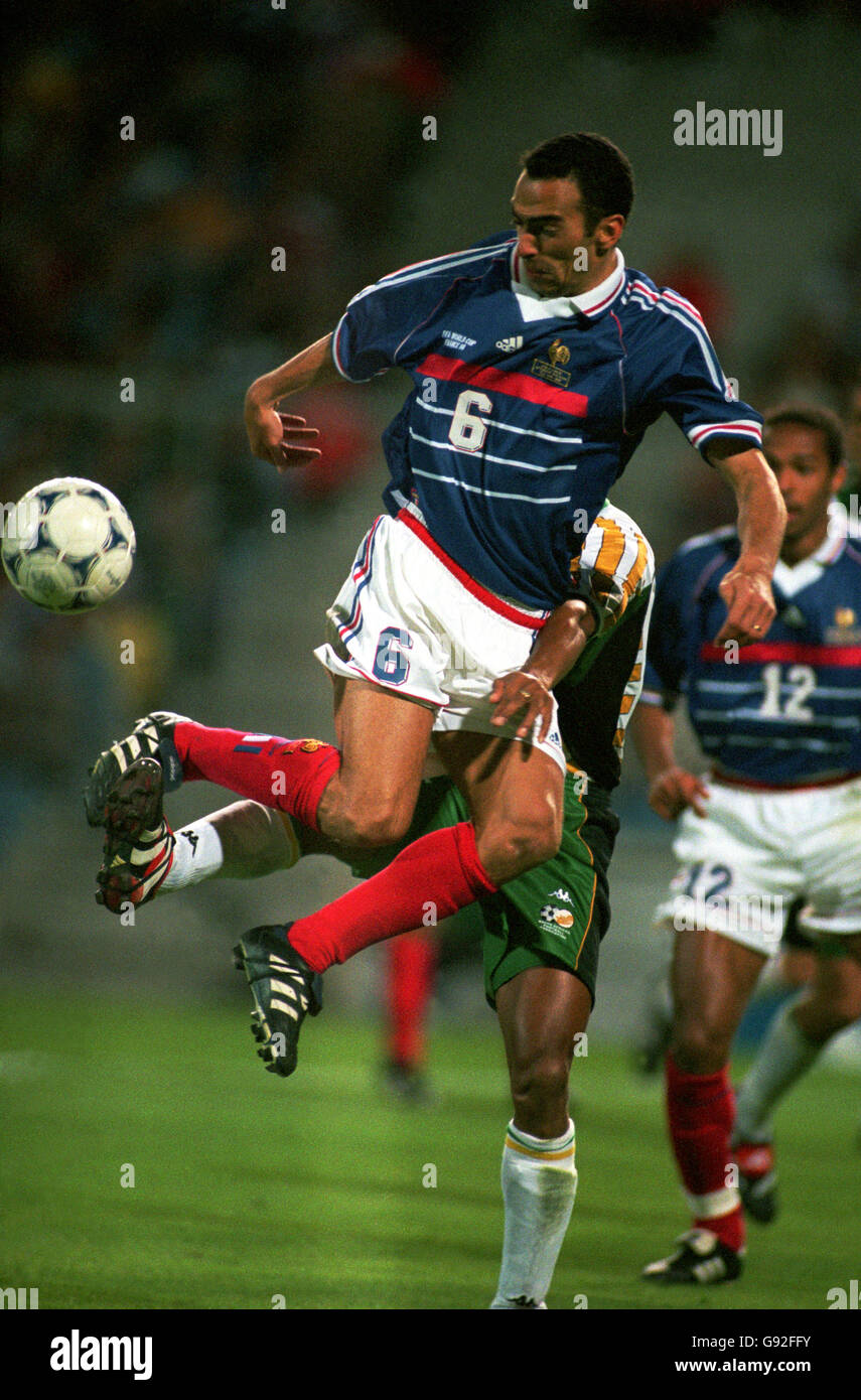Youri Djorkaeff of France (front) controls the ball in front of South ...
