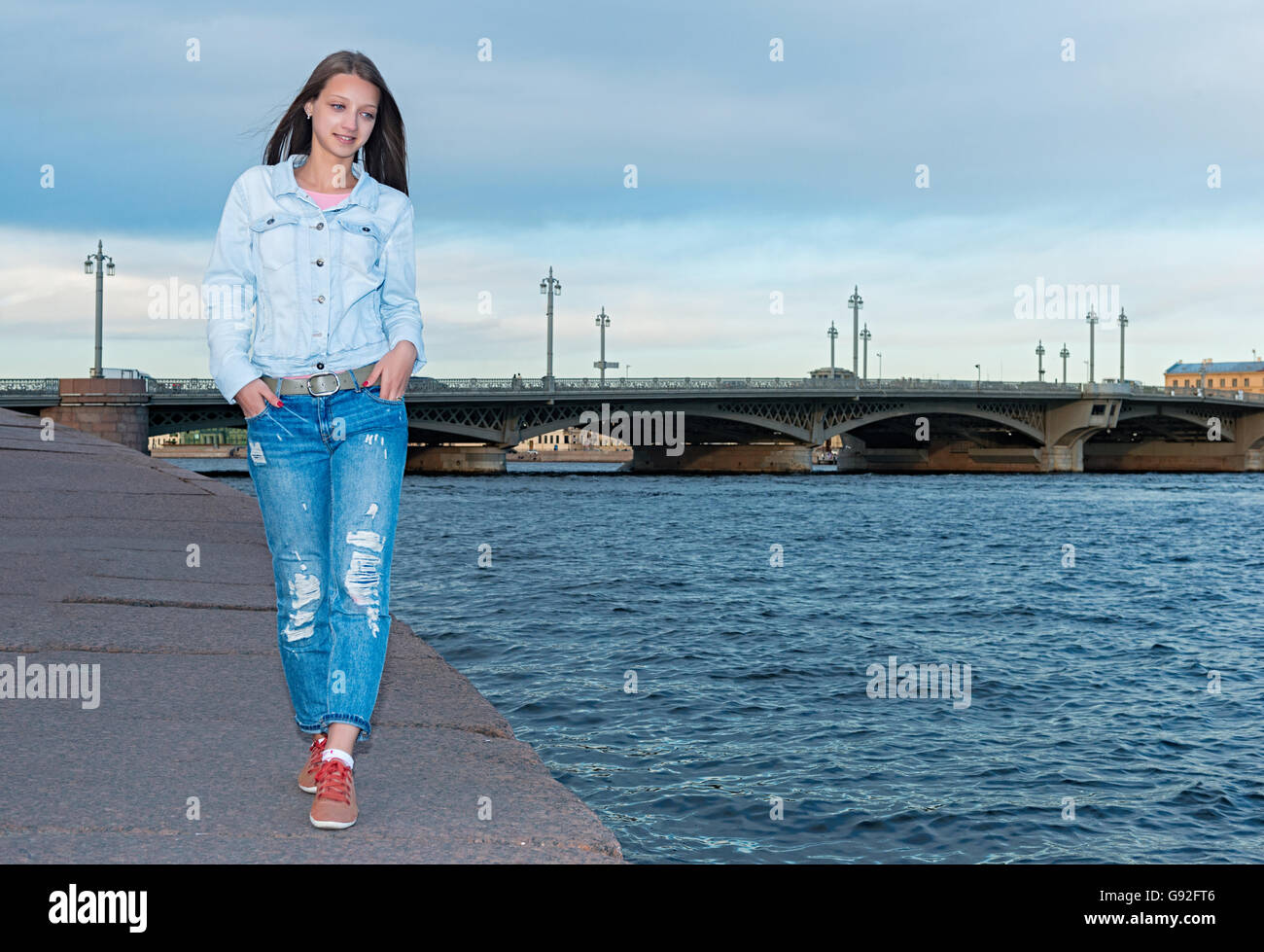 beautiful girl walks on the promenade at sunset Stock Photo - Alamy