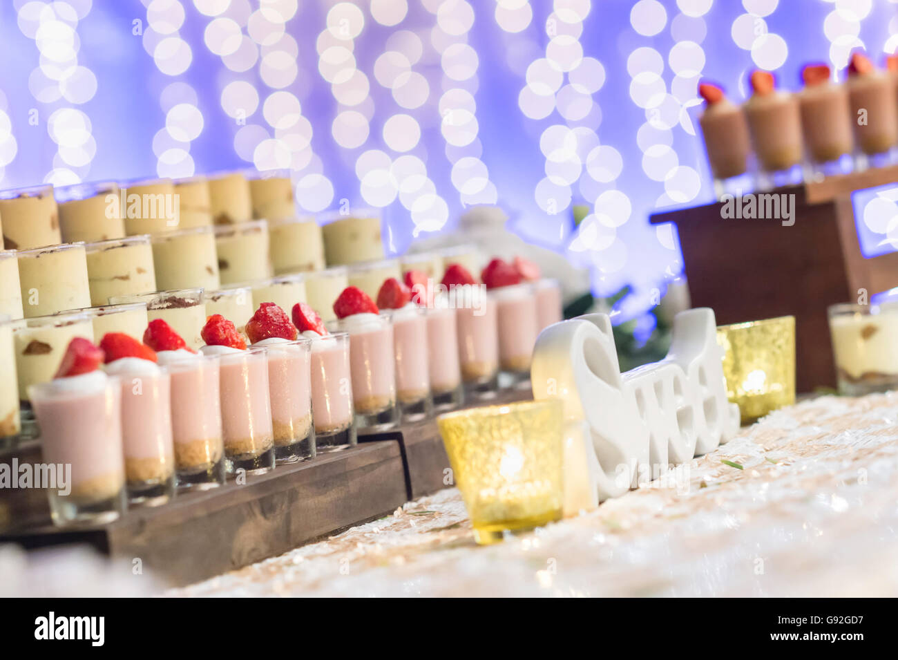 Sweet dessert on the buffet line with nice bokeh purple background ...