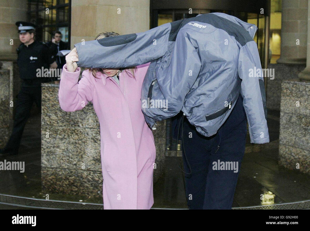 Charles Freeburn covers his face with a jacket as he leaves the High ...