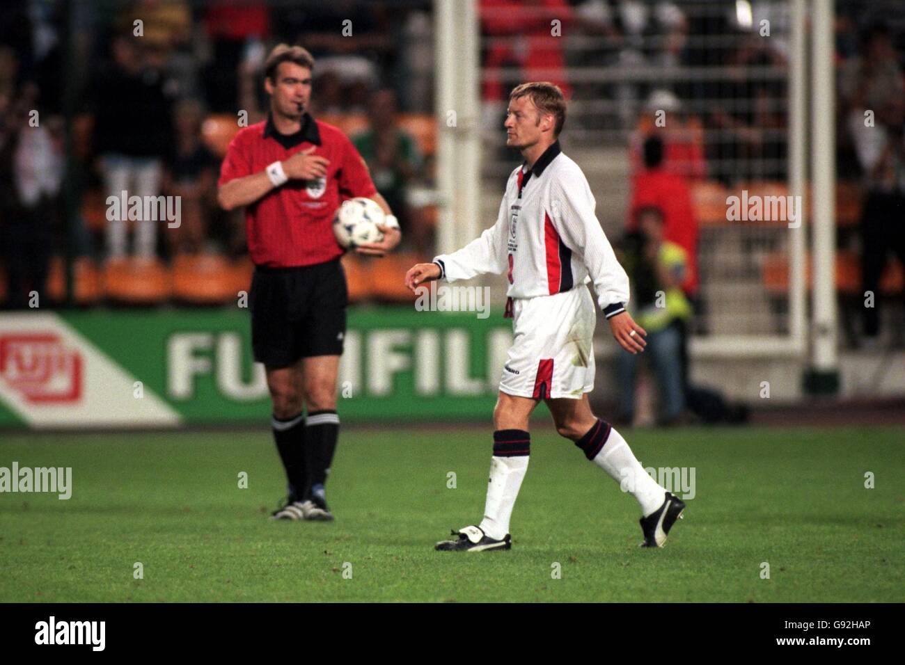 David Batty of England (right) walks off in disappointment after ...