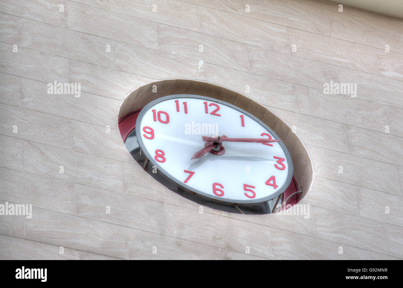 red and white clock in a tile wall Stock Photo - Alamy