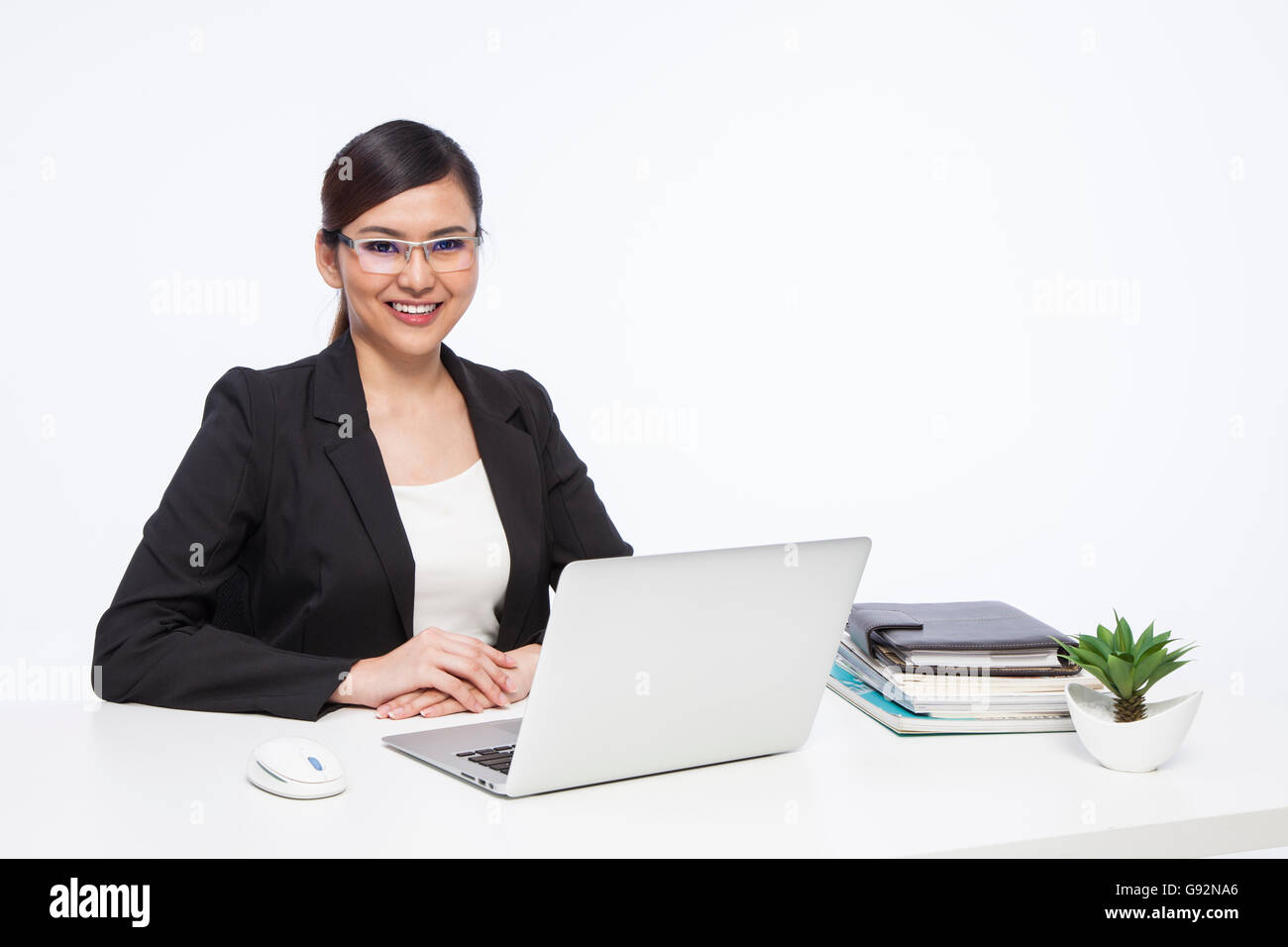 Office lady smiling in front of computer Stock Photo - Alamy