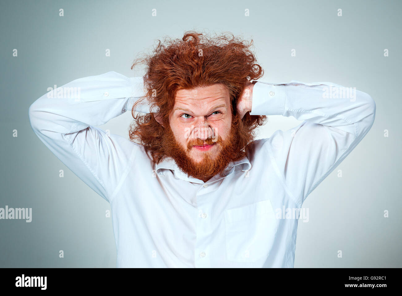 The portrait of disgusted man with long red hair Stock Photo - Alamy