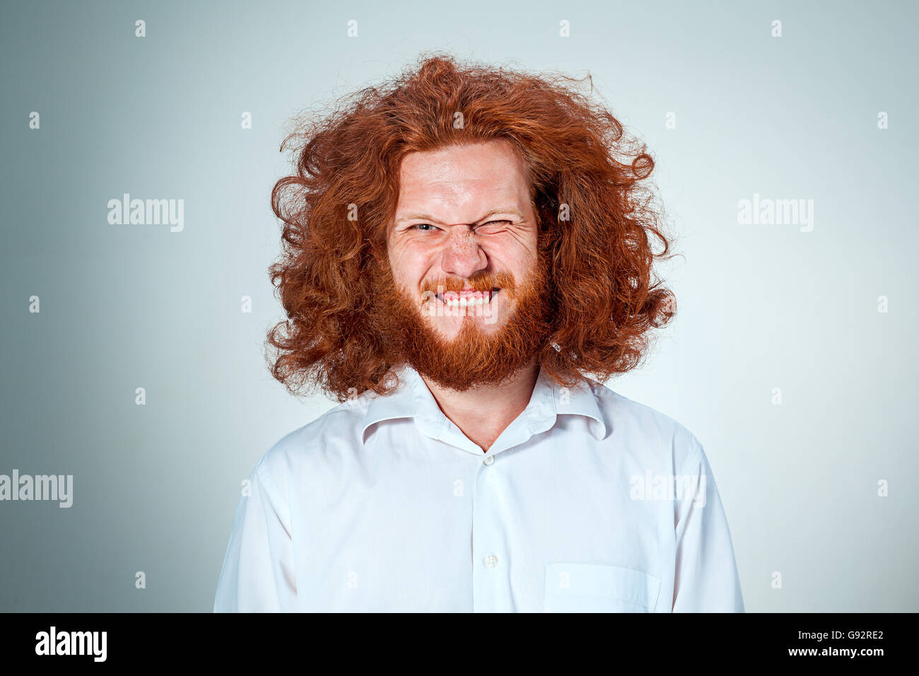 The portrait of disgusted man with long red hair Stock Photo - Alamy