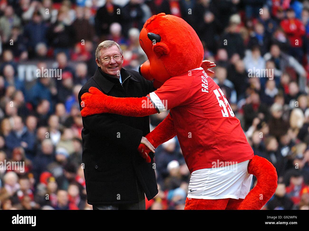 Manchester United's Alex Ferguson gets a hug from the Man Utd mascot ...