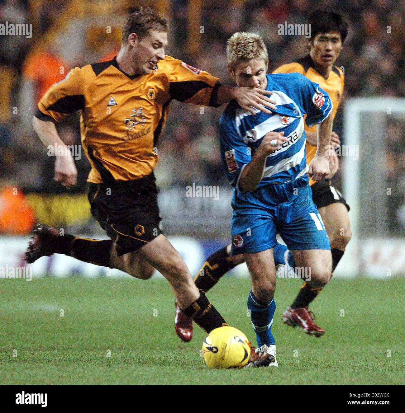 Reading's Kevin Doyle (C) battles with Wolverhampton's Gabor Gyepes (L ...