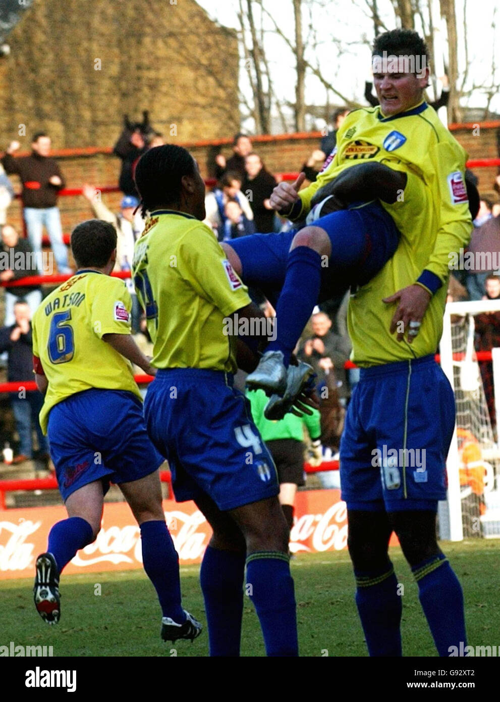 Colchester's Mark Yeates is lifted by his team mates after he scored ...