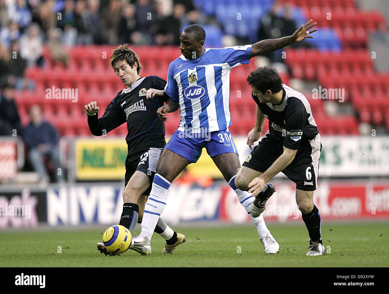 Wigan Athletic's Jason Roberts (c) tries to get away from Blackburn ...