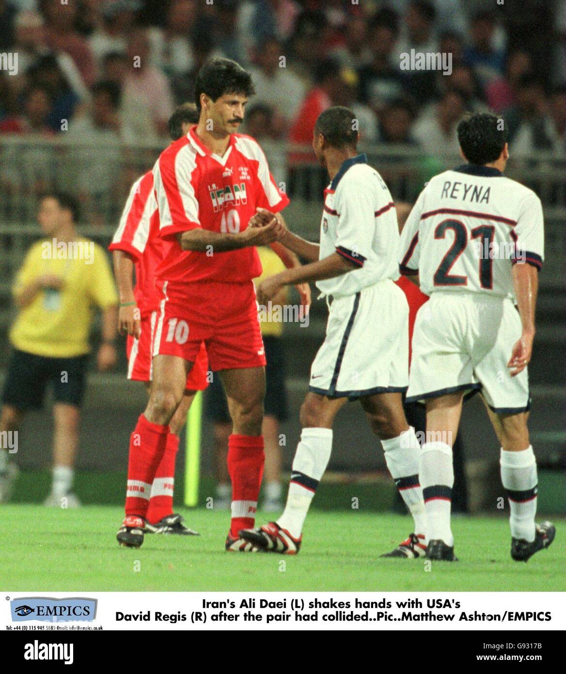 Iran's Ali Daei (left) shakes hands with USA's David Regis (right ...