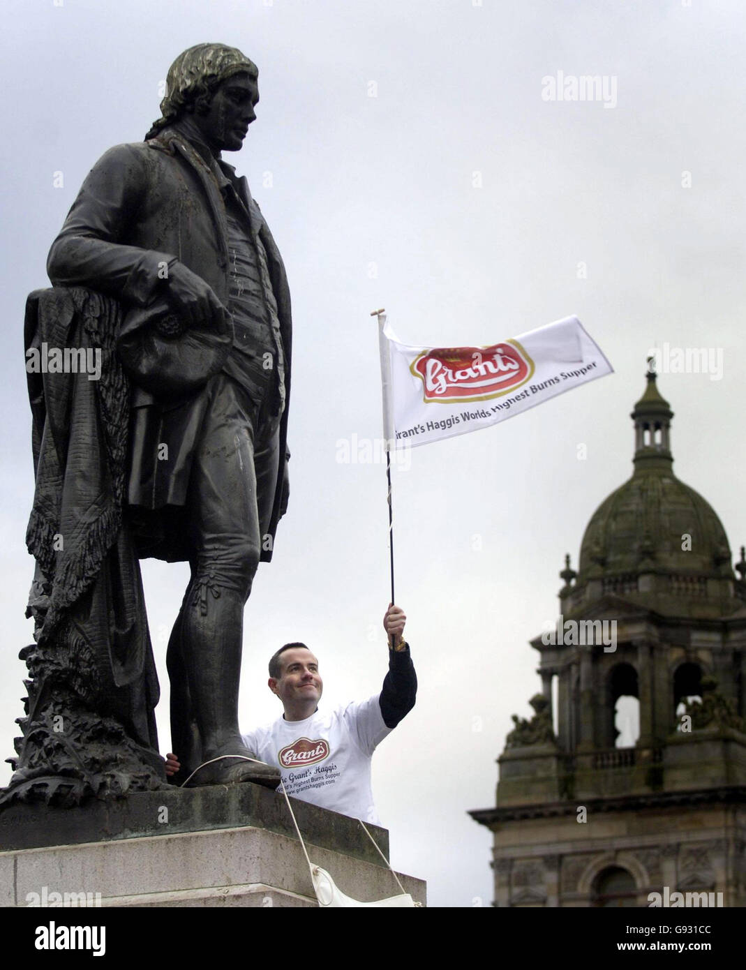 Mountaineer Chris Dunlop stands next to a statue of Robert Burns in ...