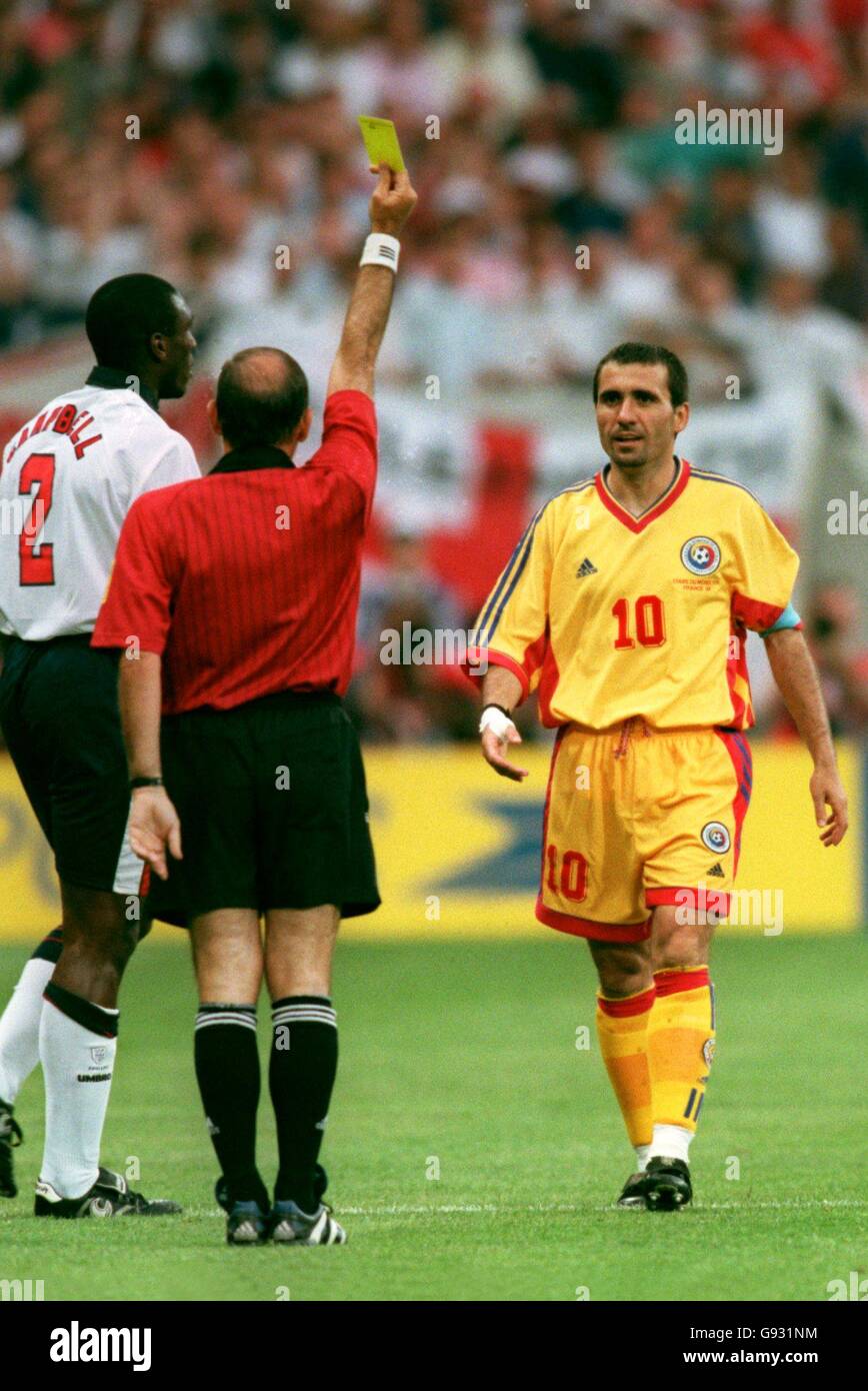 Romania's Gheorghe Hagi (right) is shown the yellow card by referee ...