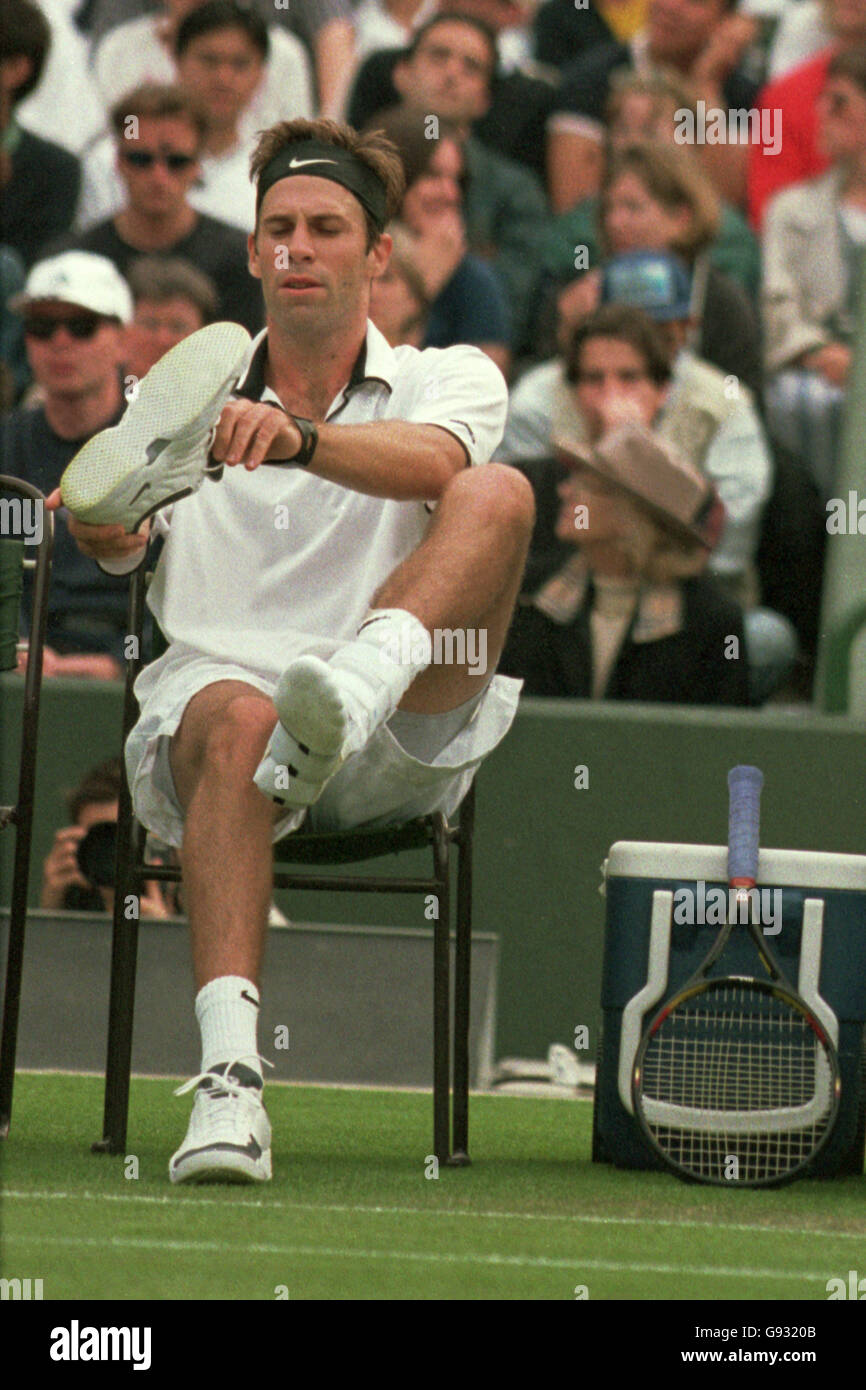 Greg Rusedski removes his shoe to reveal his heavily strapped ankle ...