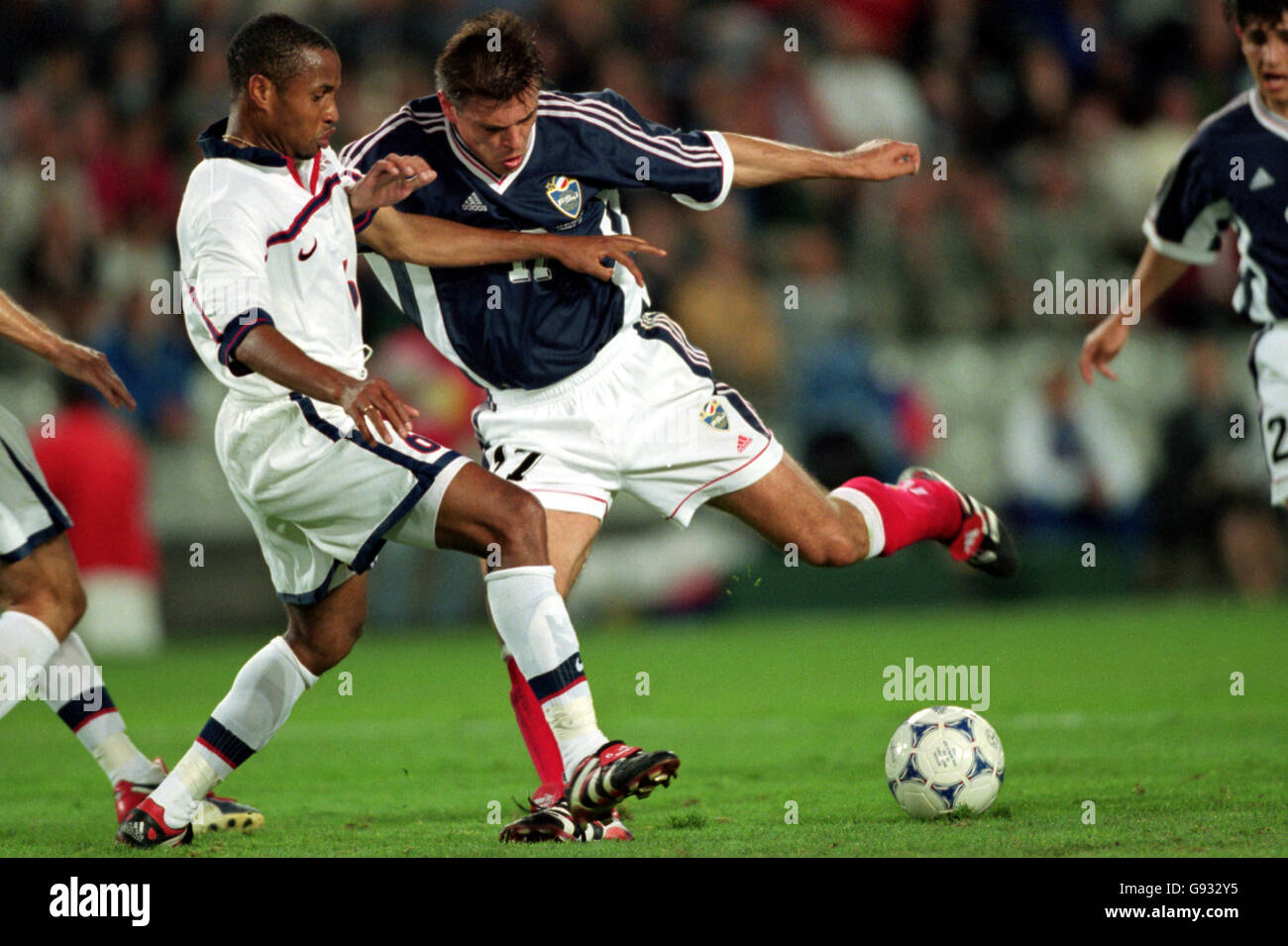 Savo Milosevic of Yugoslavia (right) gets in a shot despite the ...