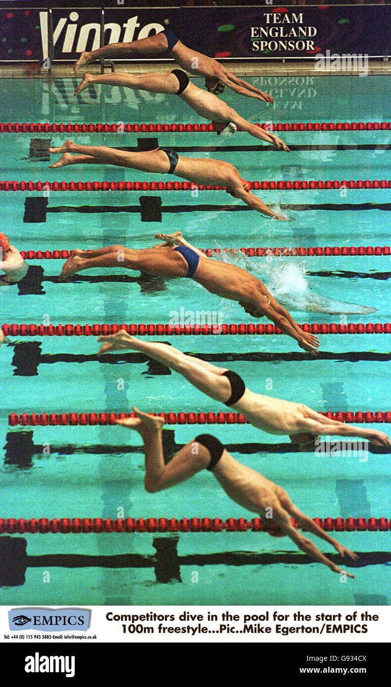 Competitors dive in pool start mens 100m freestyle hi-res stock ...