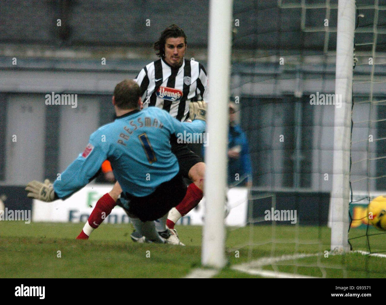 Grimsby's Michael Reddy fires the opening goal past Mansfield's goal ...