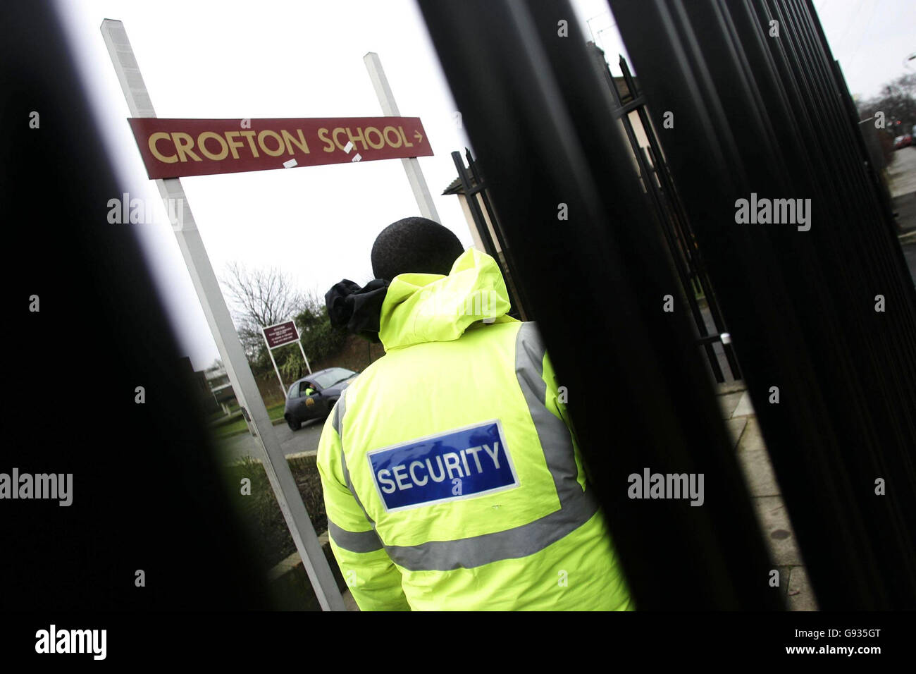 A security guard stands at the gates of crofton school hi-res stock ...