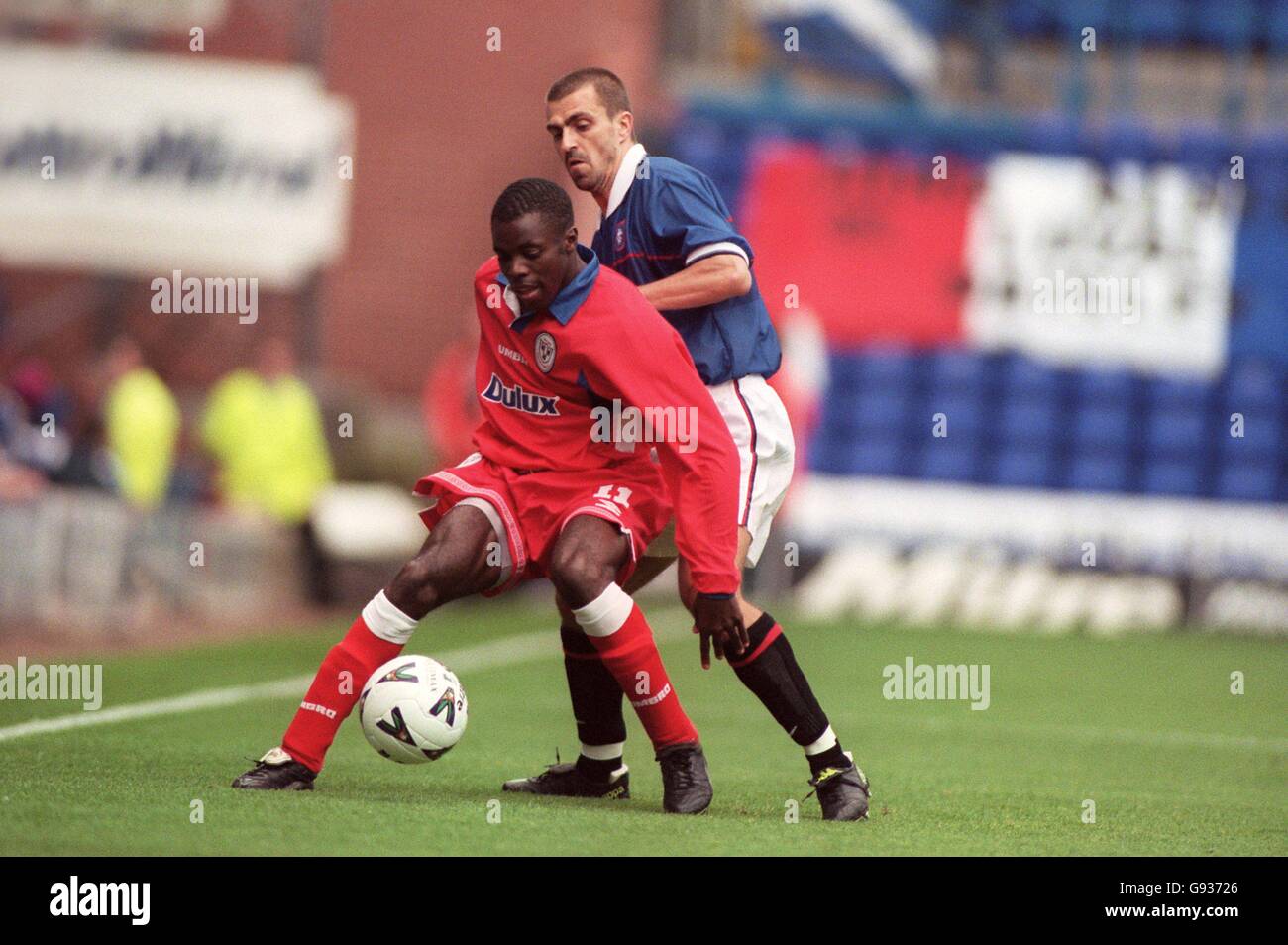 Mark Rutherford of Shelbourne (left) shields the ball from Sergio ...