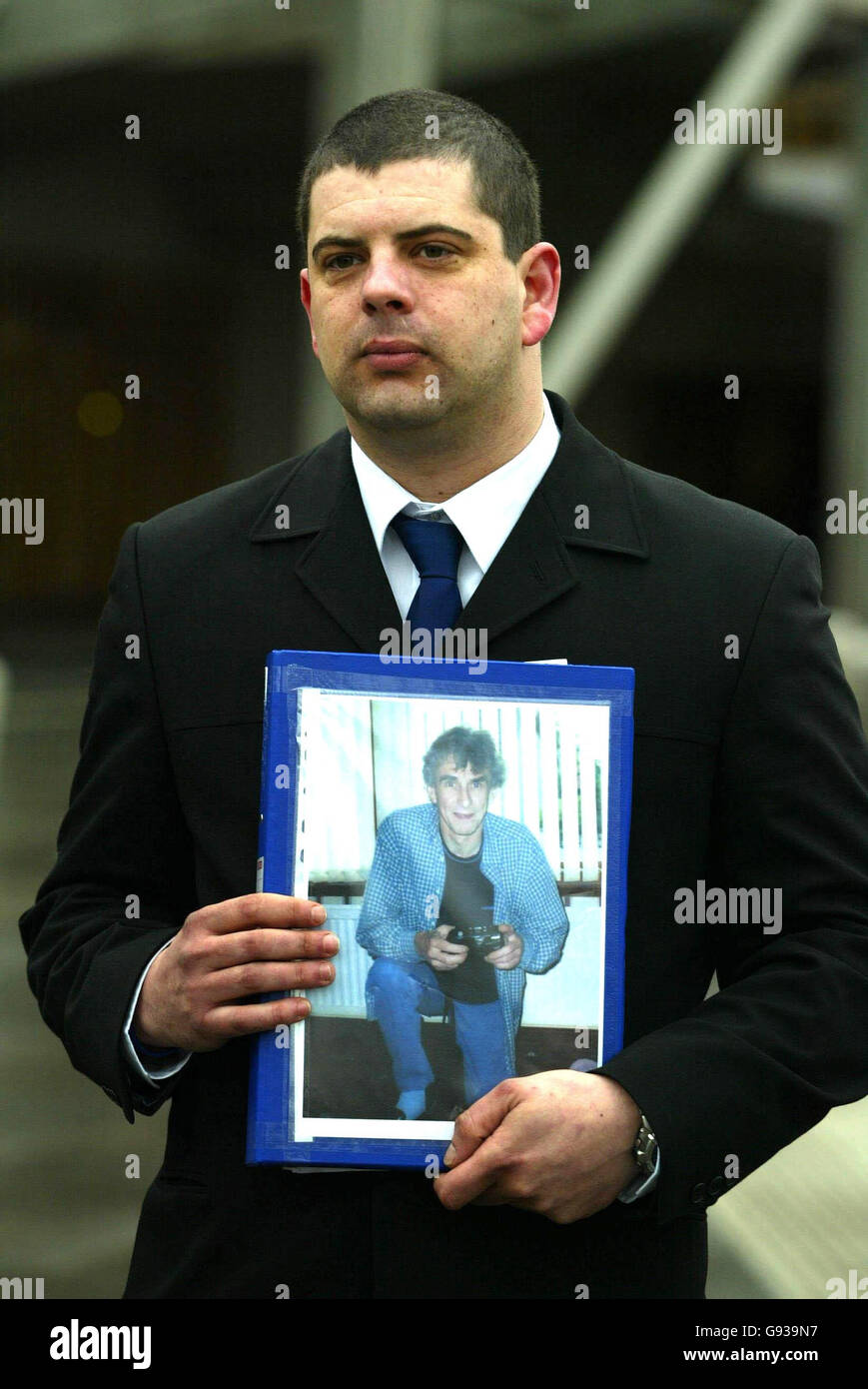 Kevin Herd with a photograph of his dead father George at the Scottish ...