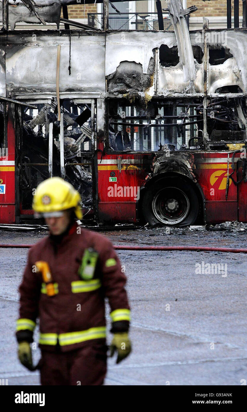 A fireman walks past the wreakage of one of the fourteen buses ...