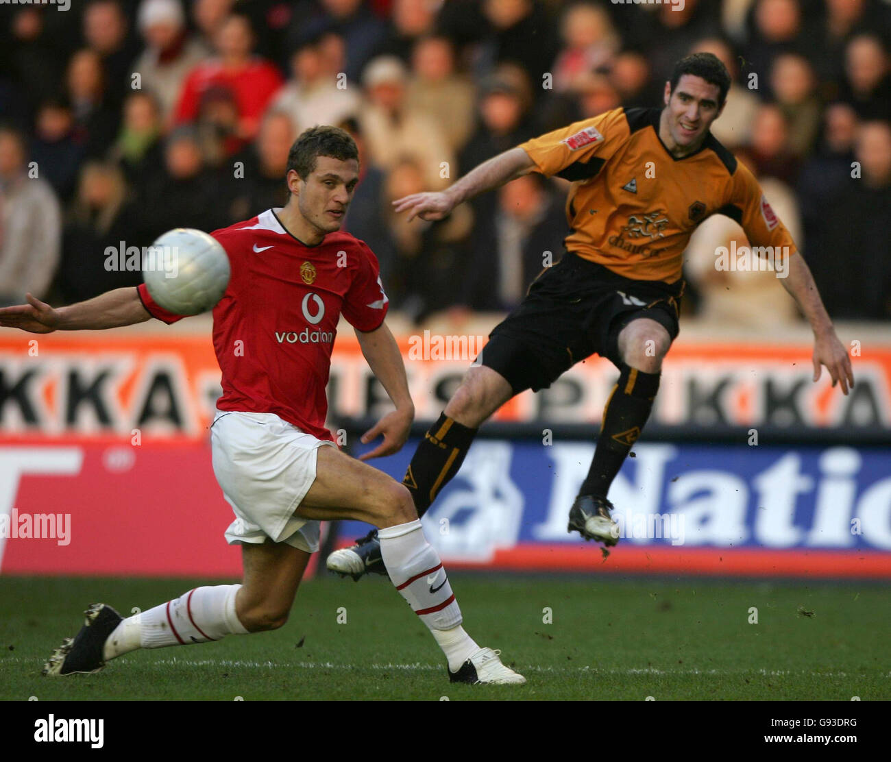 Manchester United's Nemanja Vidic (L) blocks a cross from Wolverhampton ...