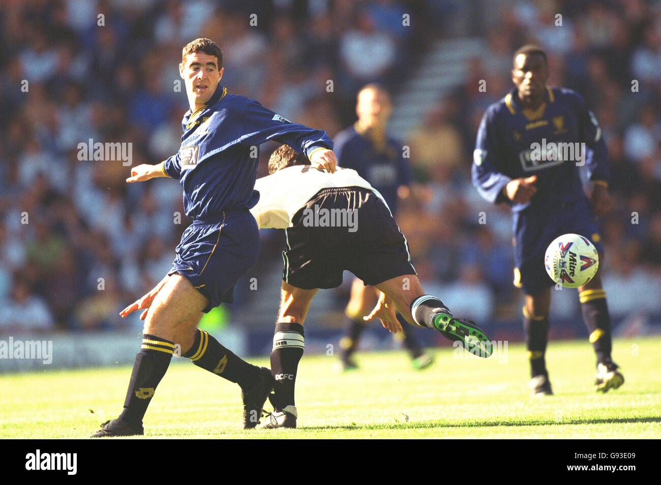 The ball eludes Wimbledon's Mark Kennedy (left) and Derby County's Rory ...