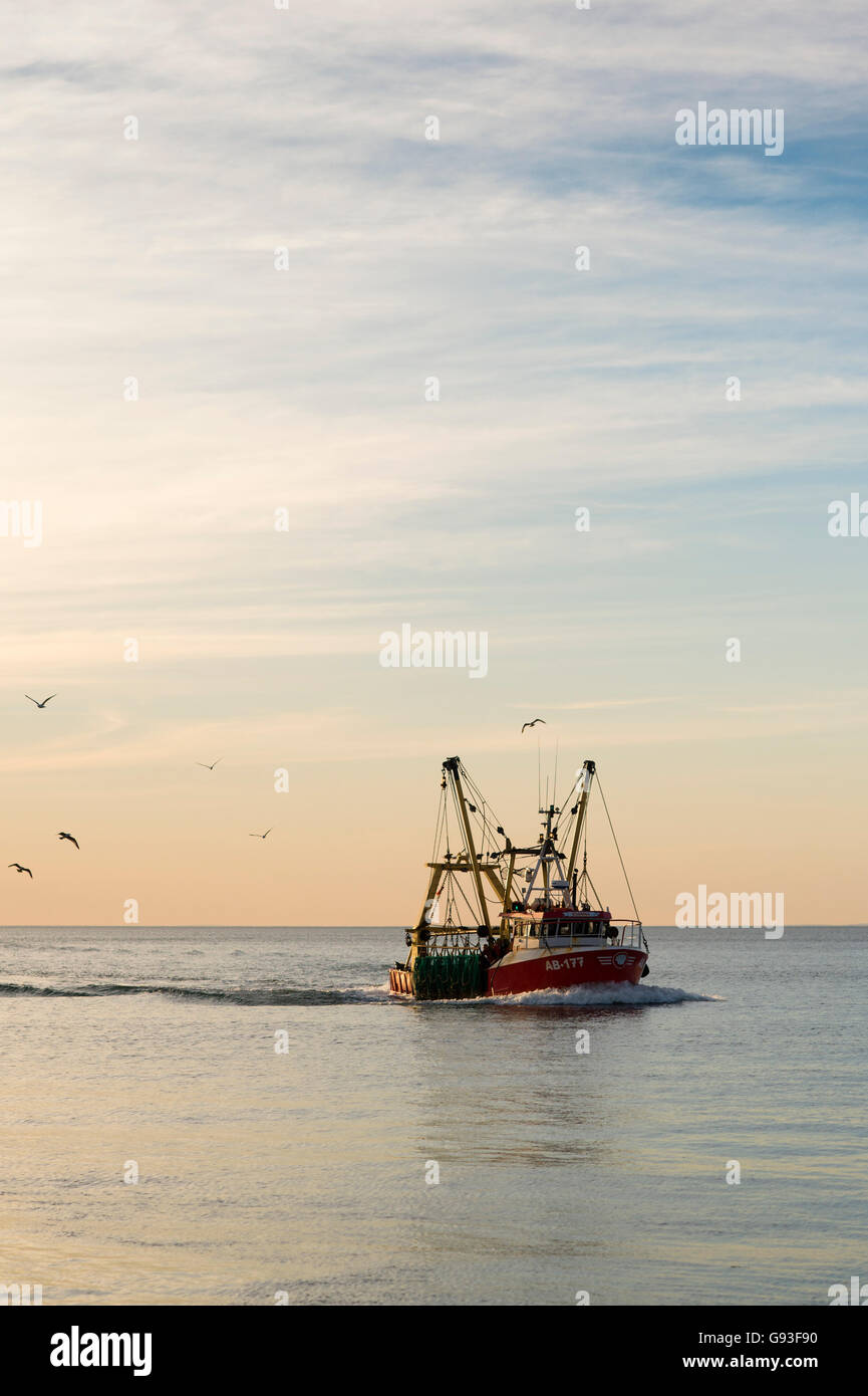 A small inshore fishing boat returning to Aberystwyth harbour with its ...