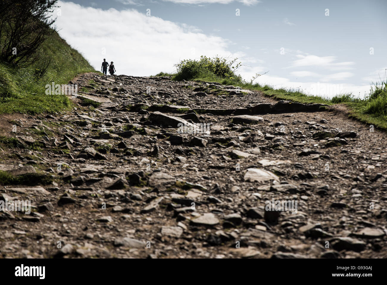 A couple walking on a scree slope Stock Photo - Alamy