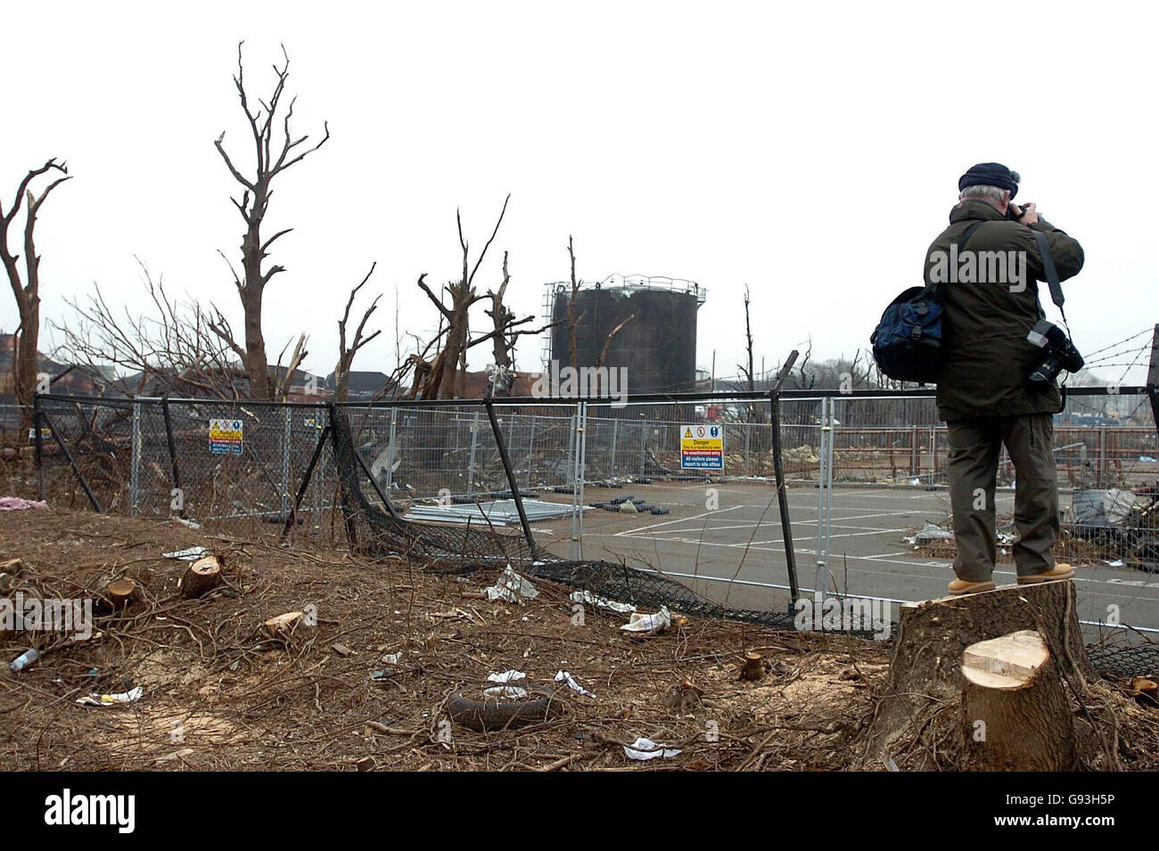 A photographer records the scene of devastation at the site of the ...