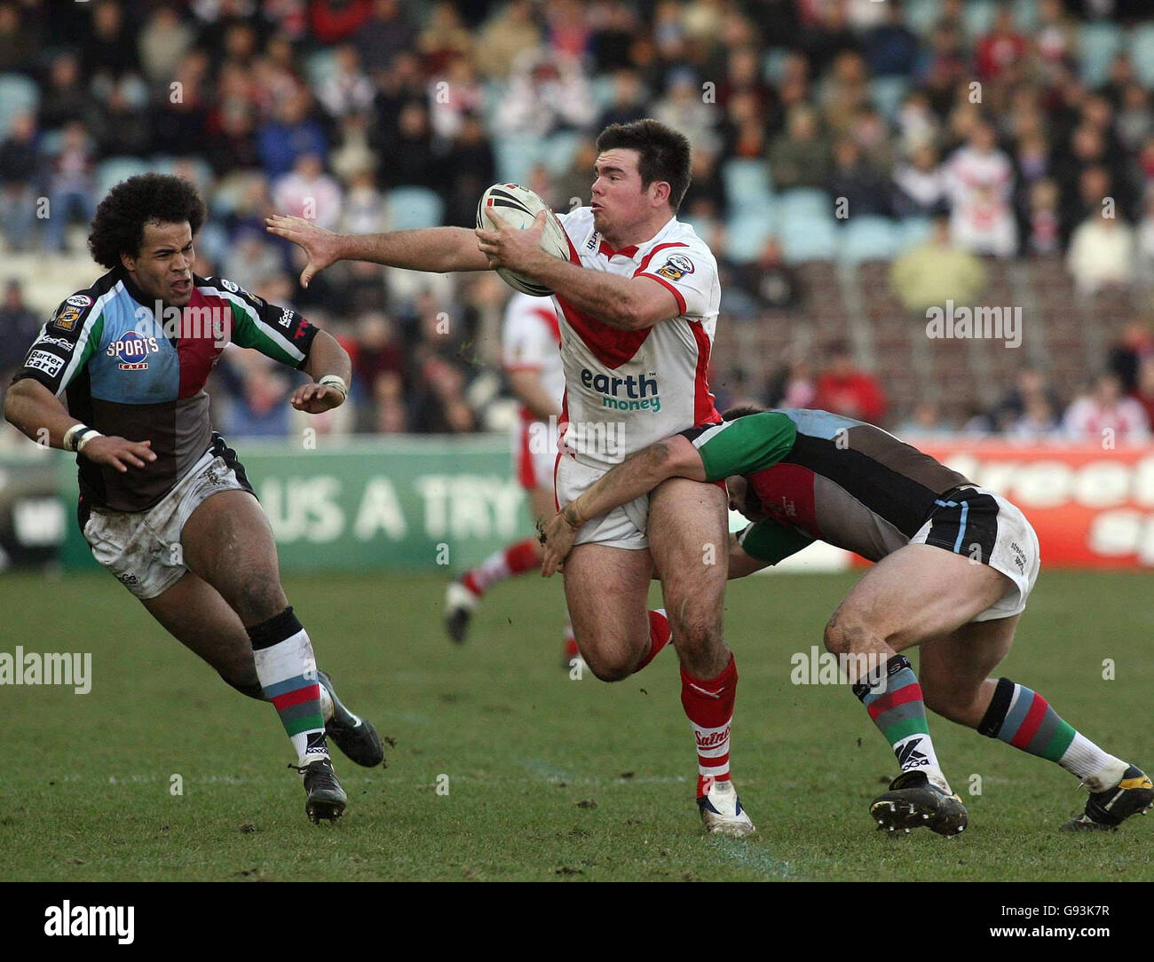 St Helens' Jamie Lyon is brought down by Harlequins' Lee Hopkins during ...
