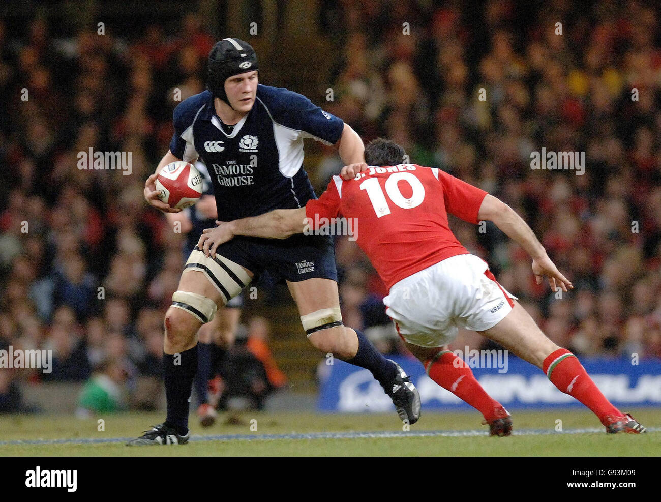 Wales' Stephen Jones tackles Scotland's Simon Taylor during the RBS 6 ...