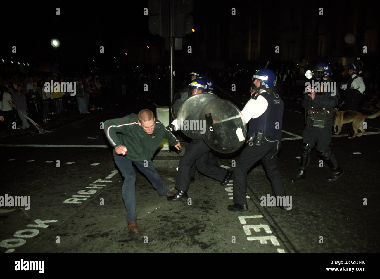 Riot police clash with an England supporter in Trafalgar Square, London ...