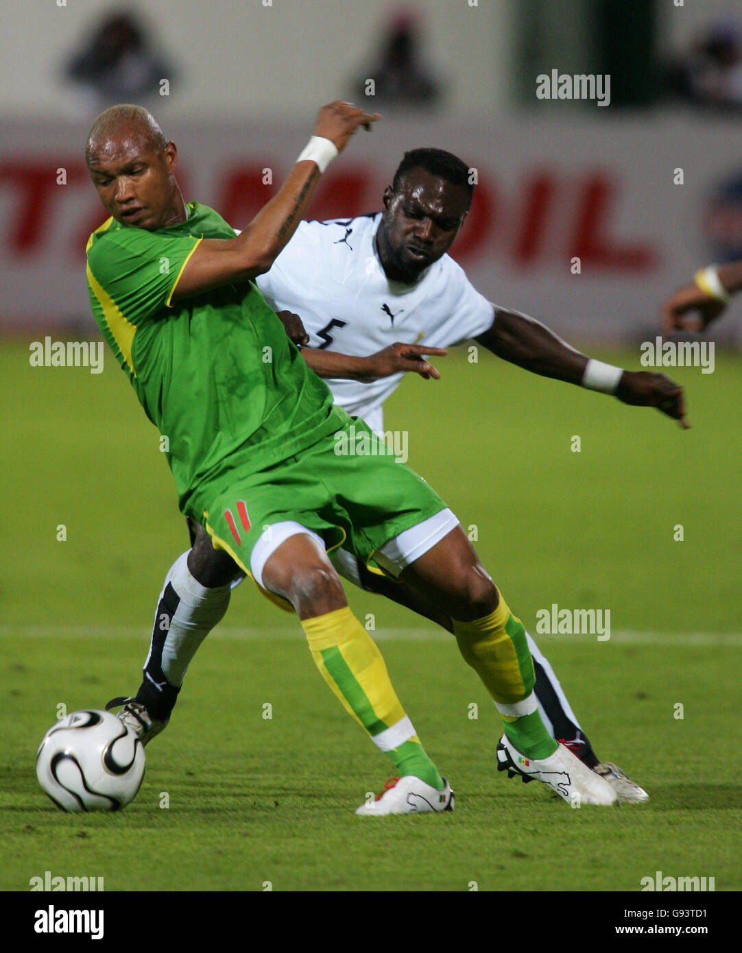 Ghana's John Mensah and Senegal's El Hadji Diouf battle for the ball ...