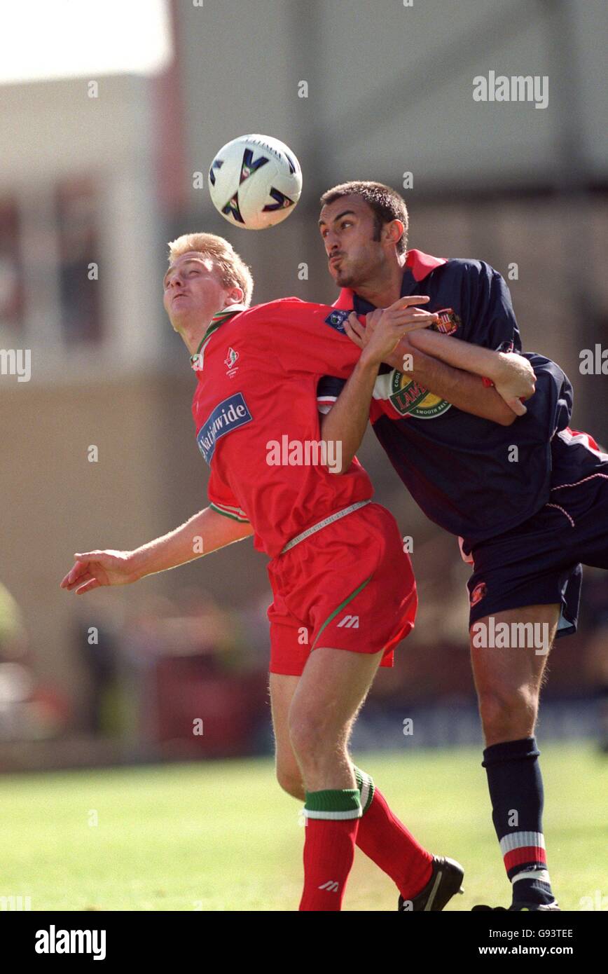 Swindon Town's Alan Reeves (left) fights for an aerial ball with ...