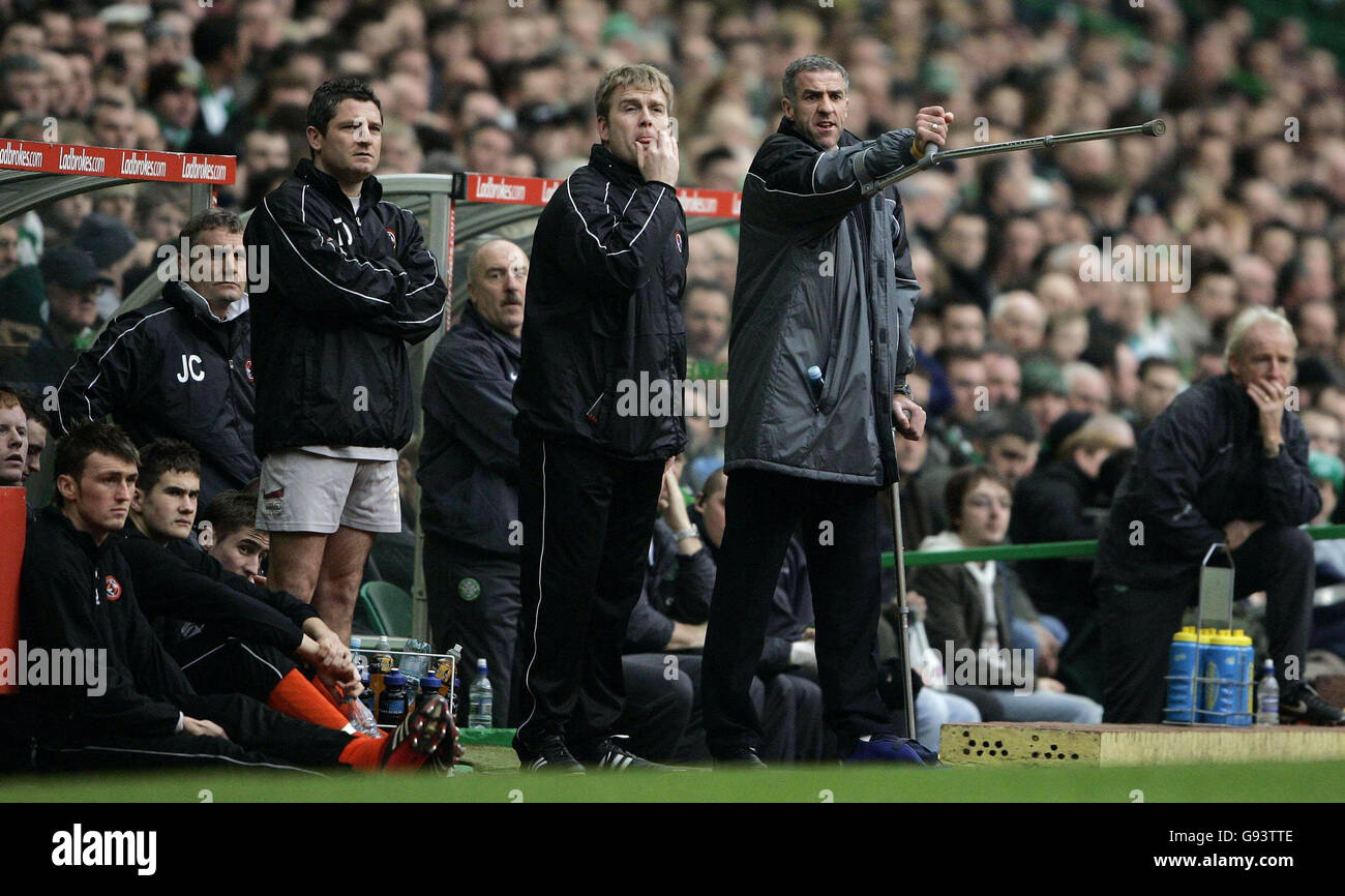 Dundee United's bench and manager Craig Brewster with crutches urges ...