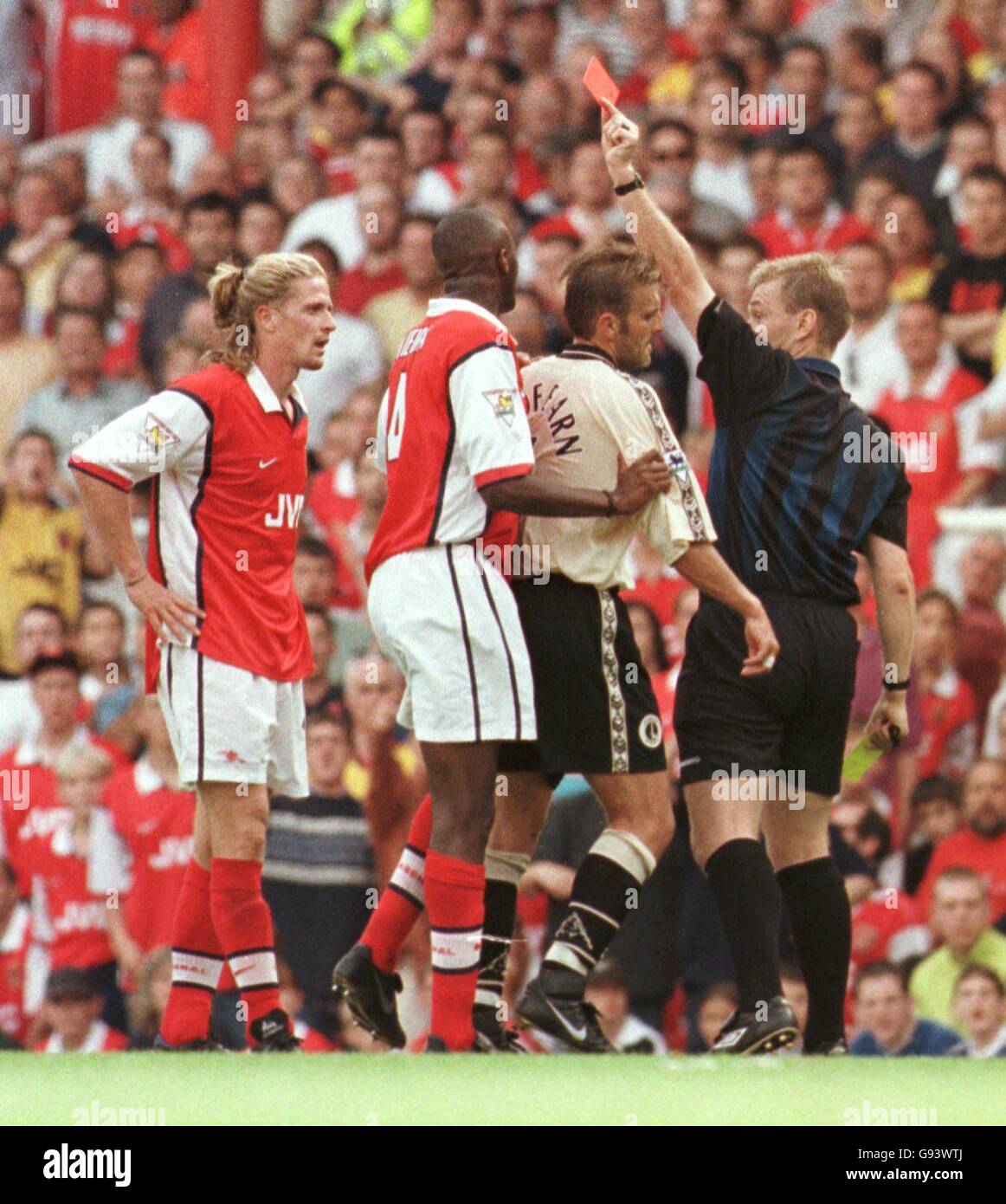 Arsenal's Emmanuel Petit (left) is shown the red card by referee Graham ...