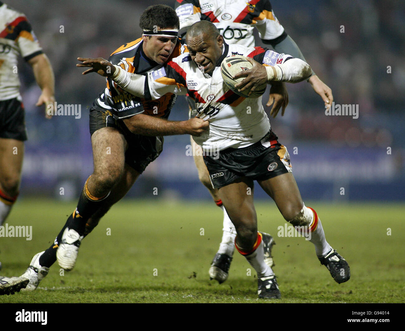 Bradford Bulls' Stanley Gene (R) is tackled by West Tigers' Sam Harris ...