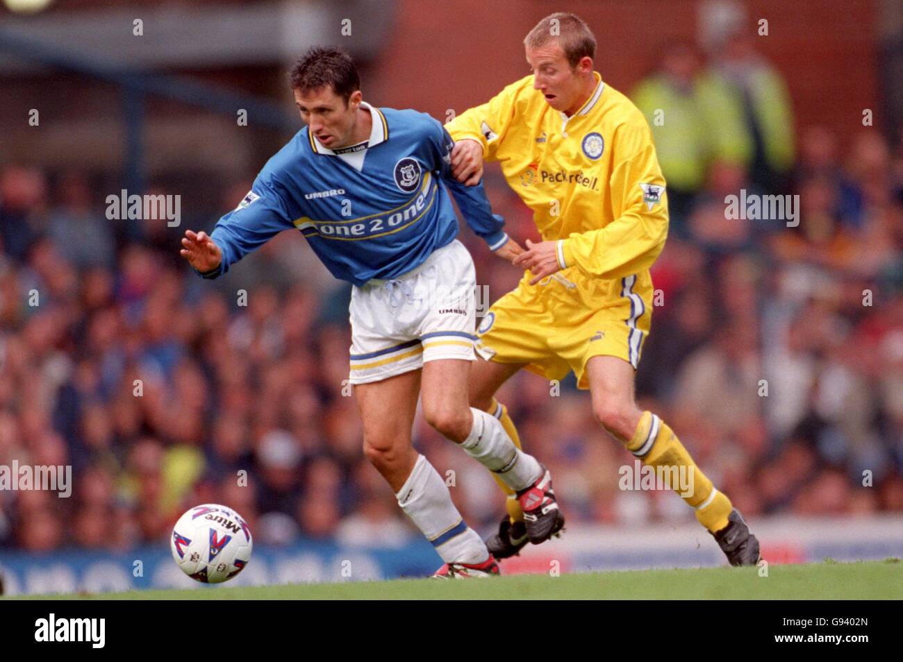 Lee Bowyer of Leeds United (right) puts pressure on John Collins of ...