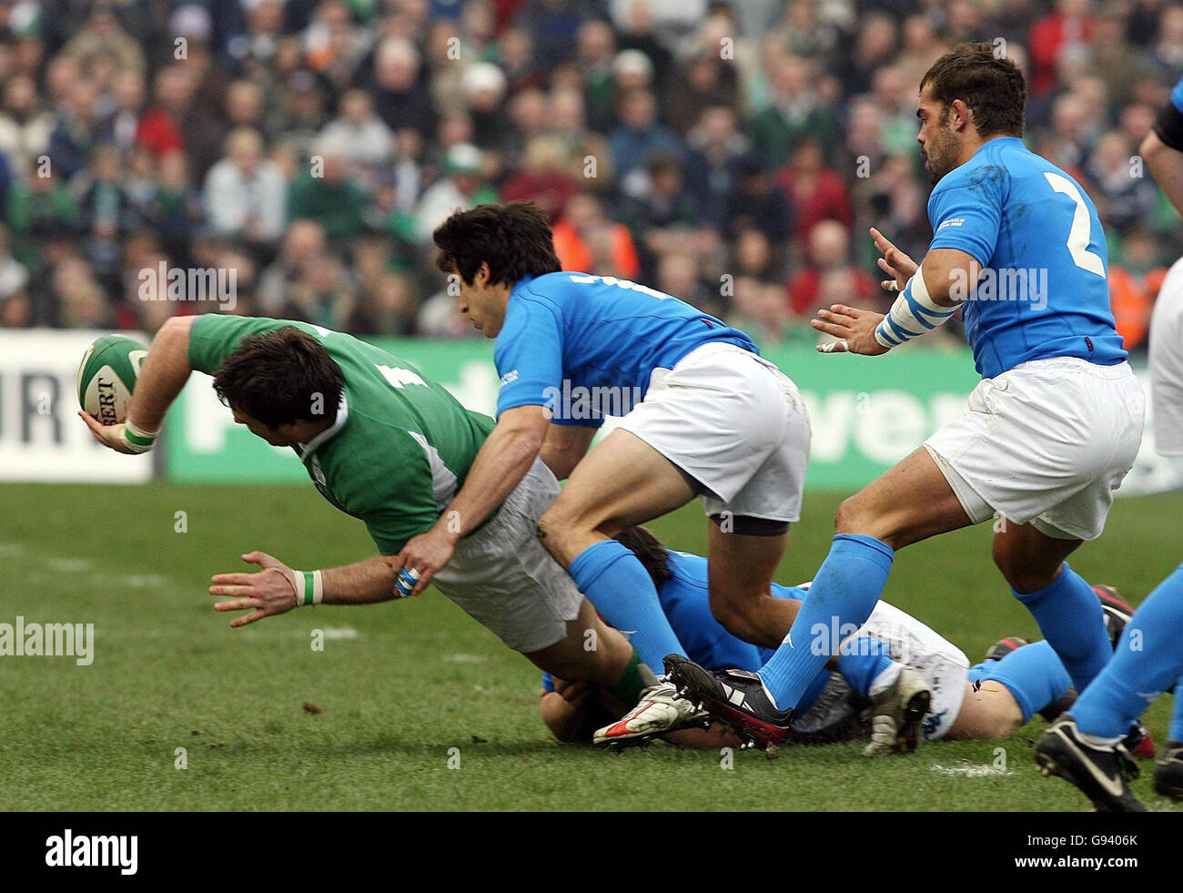 Ireland's Marcus Horan (L) scoops the ball clear from Italy's Salvatore ...