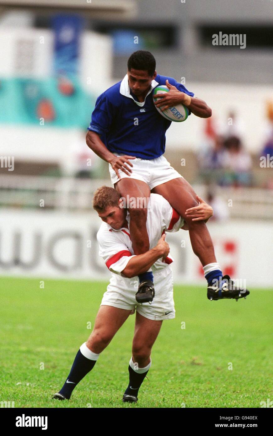 England's Nick Baxter (bottom) tackles Western Samoa's Toa Samania (top ...