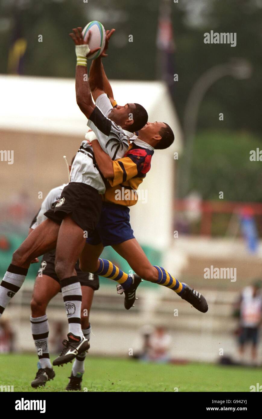 Fiji's Rauqe Senirusi (left) wins the line out ball under pressure from ...