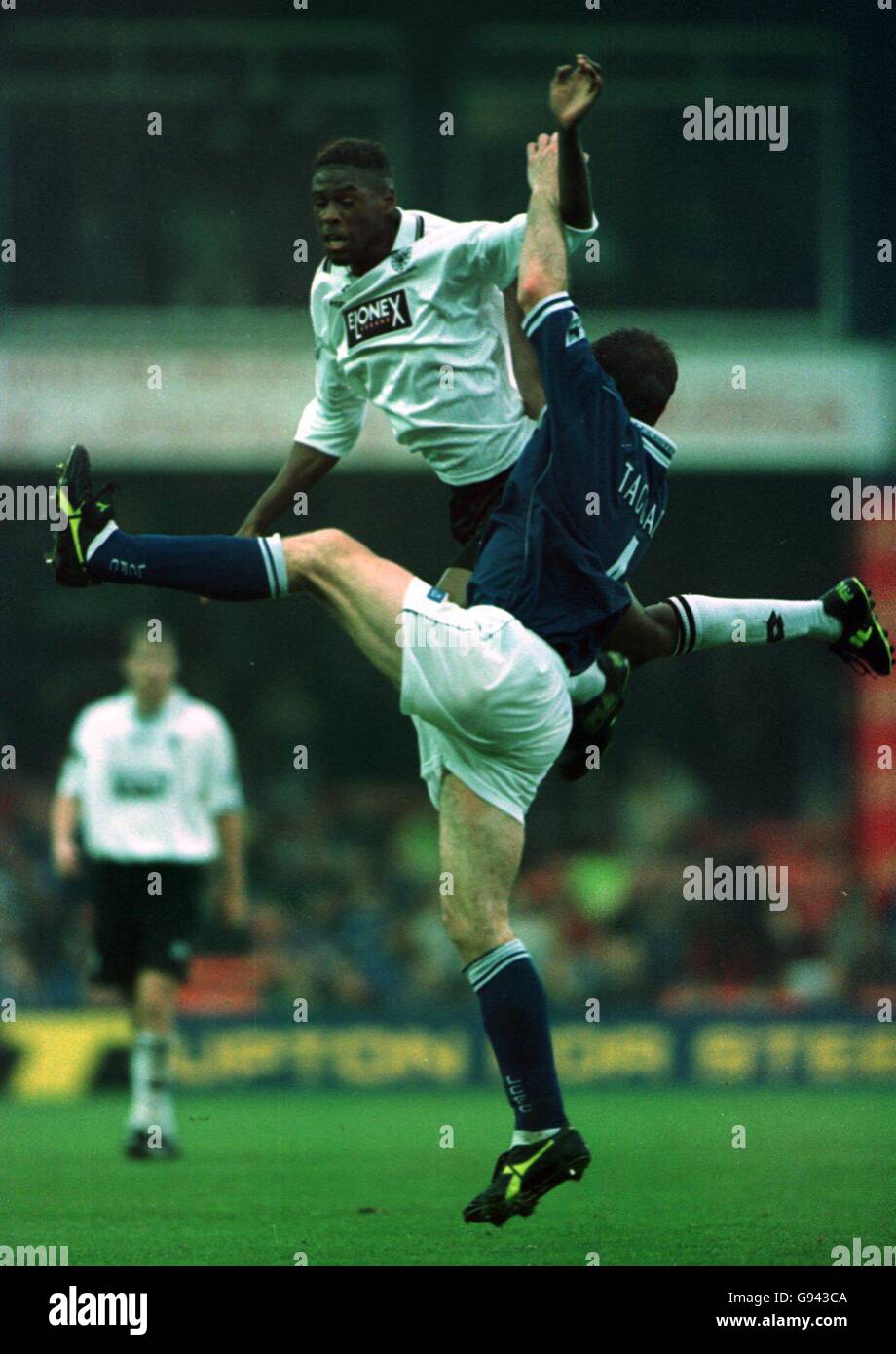 Carl Cort of Wimbledon (top) in an aerial battle with Gerry Taggart of ...