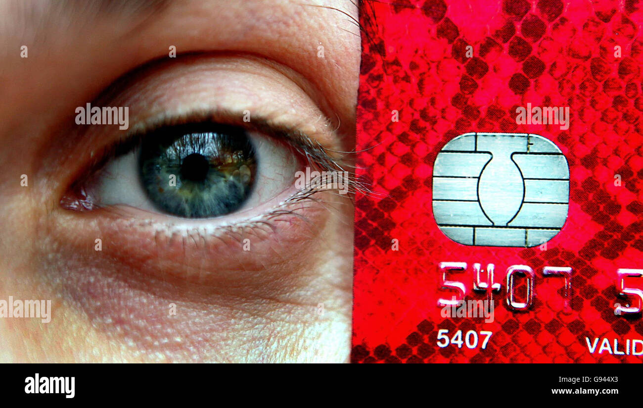 A member of the public displays his chip and pin credit card in central ...