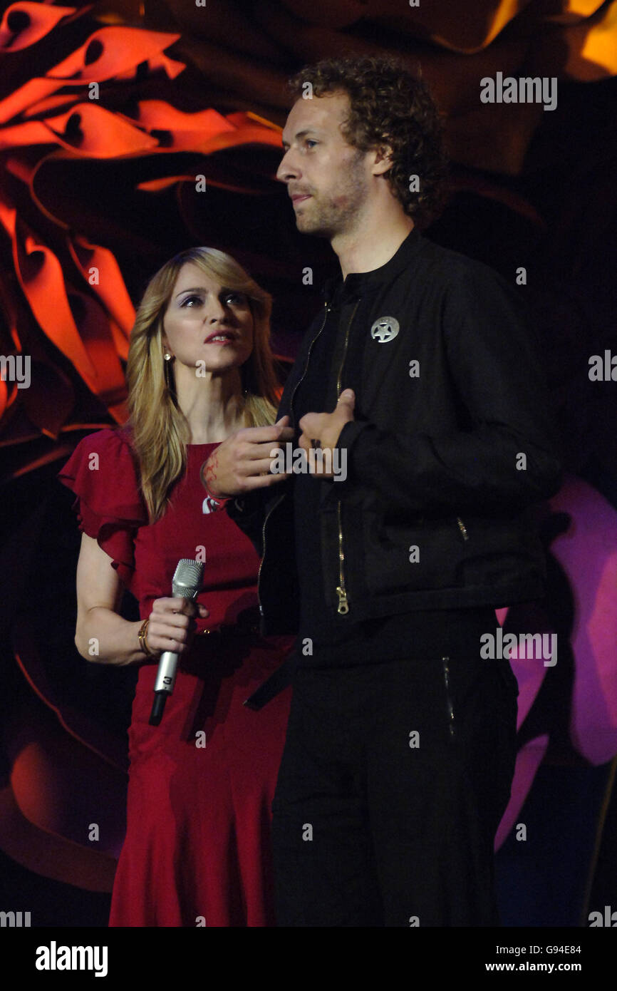 Madonna on stage with Coldplay lead singer Chris Martin as they collect ...