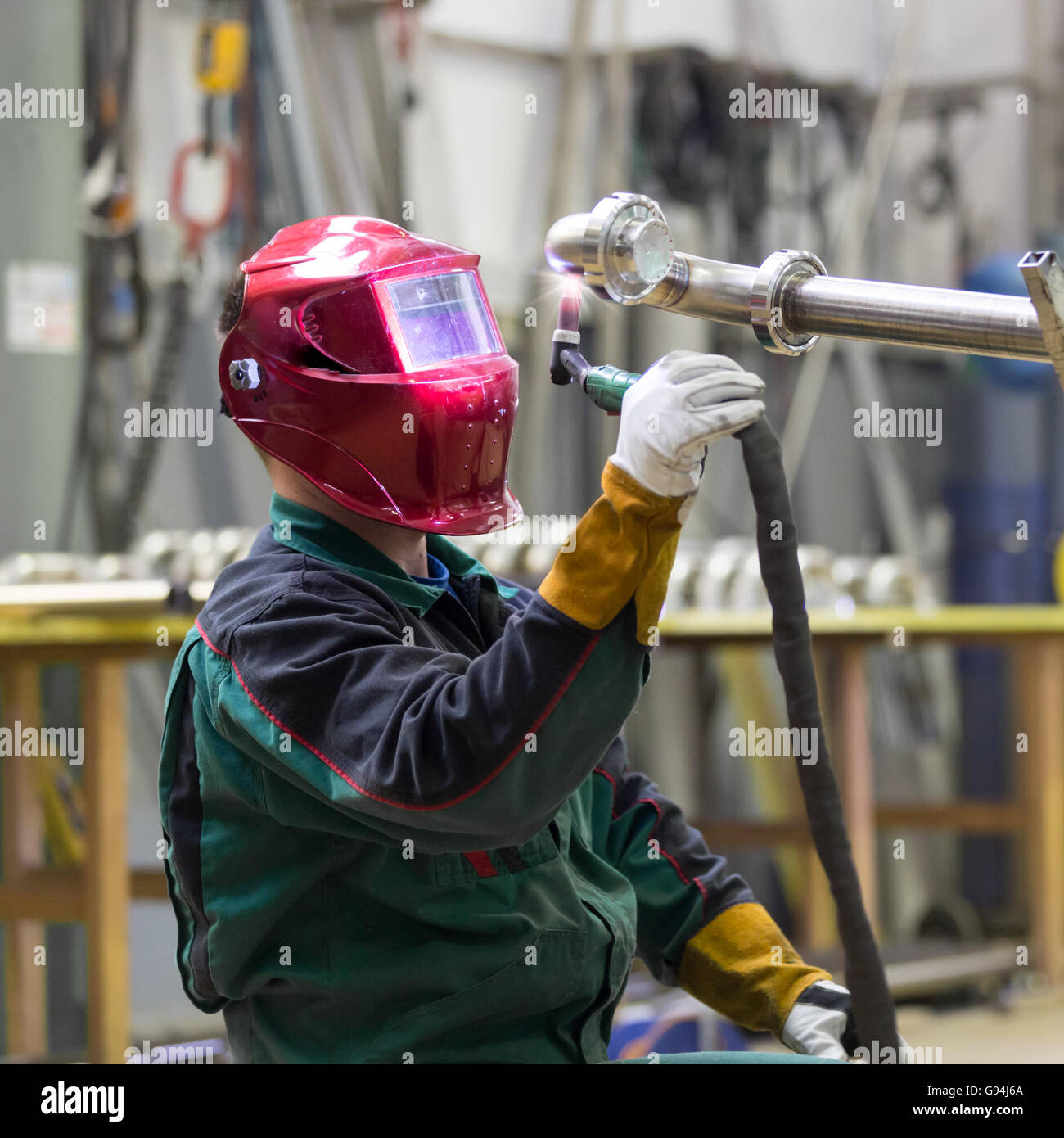 Industrial worker welding in metal factory Stock Photo - Alamy
