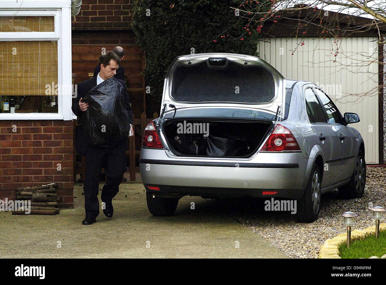 Police officers remove black bags from the home of Neil Entwistle's ...
