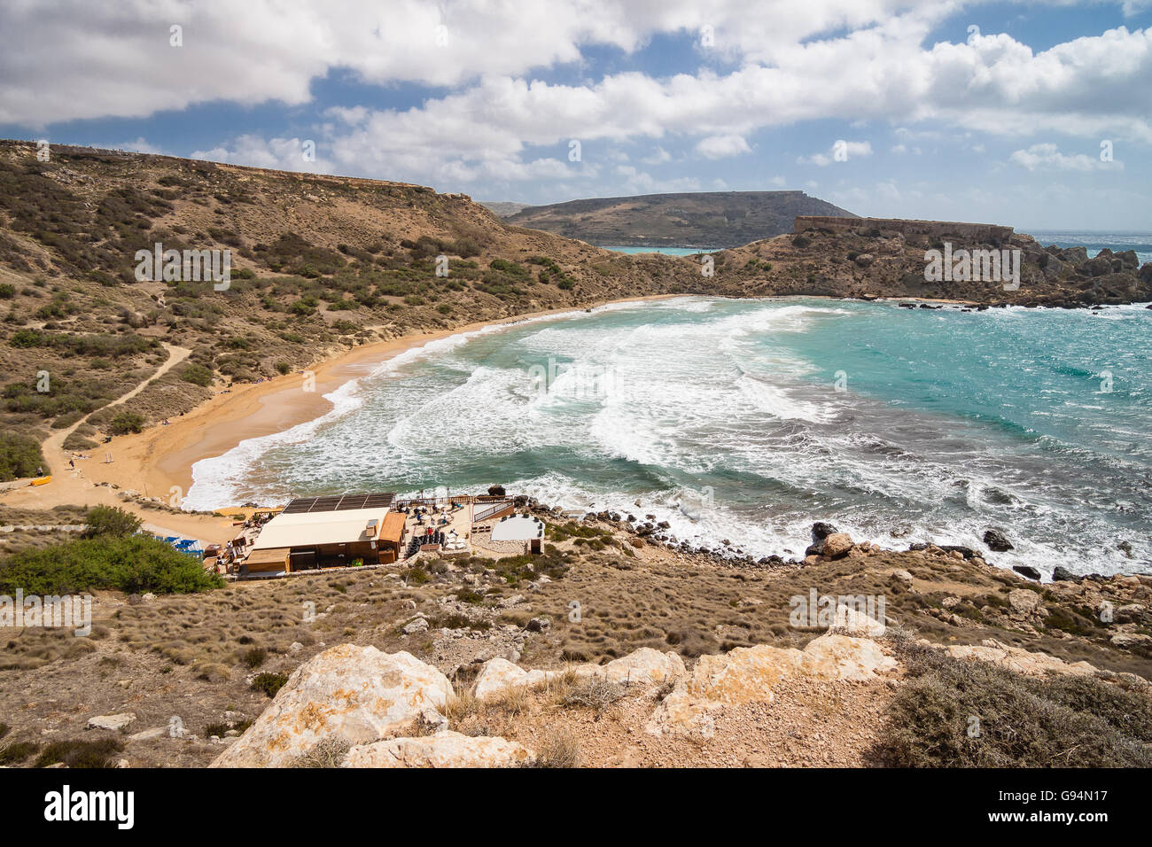 The sandy beach below the rocky cliffs of the Malta island Stock Photo ...