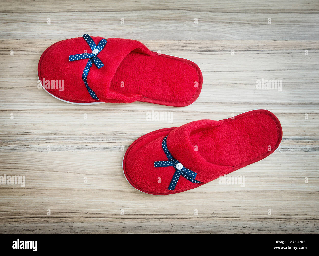 Red slippers with blue ribbon on the wooden background. Beauty and ...