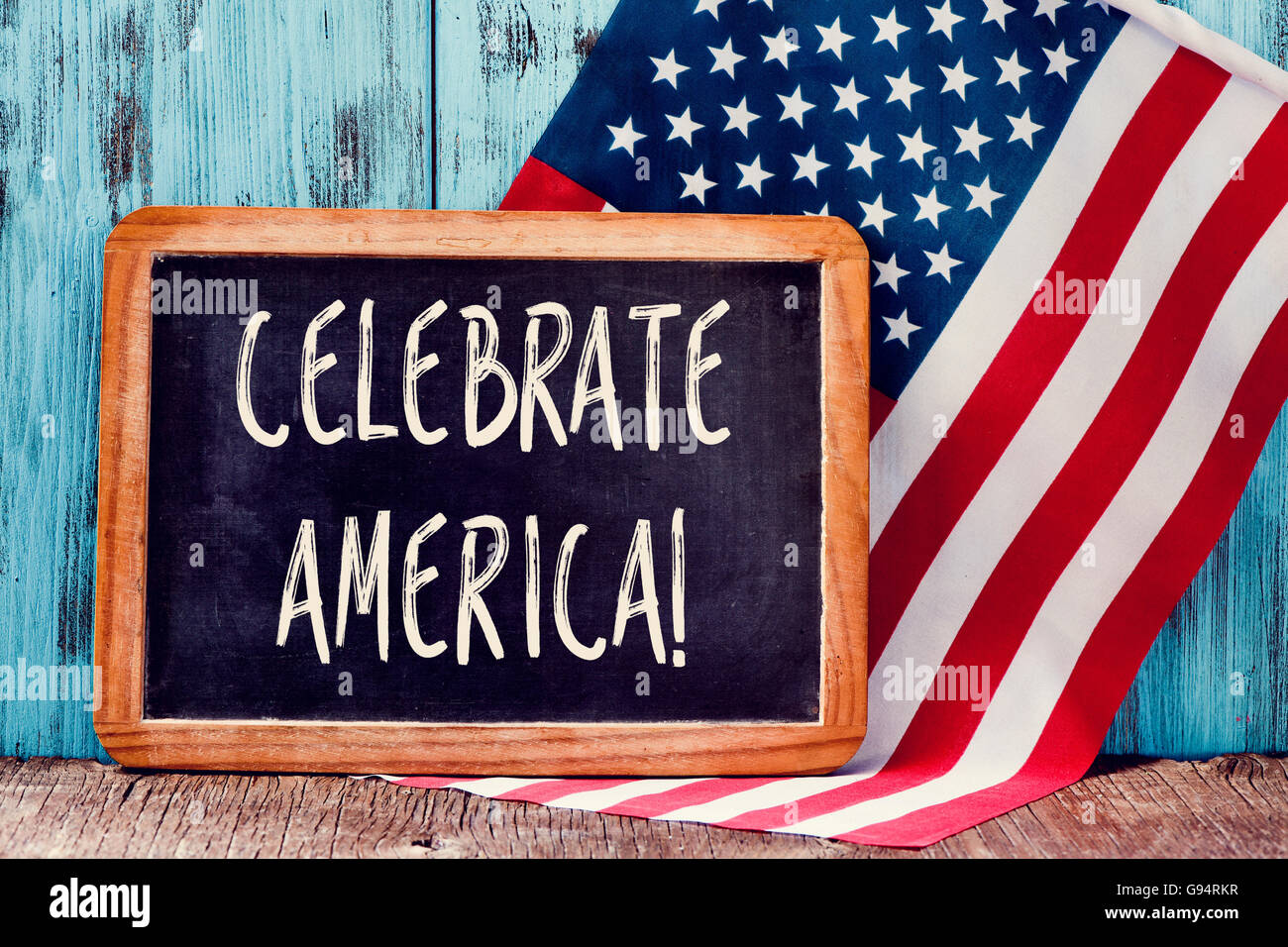 a wooden-framed chalkboard with the text celebrate America written in ...